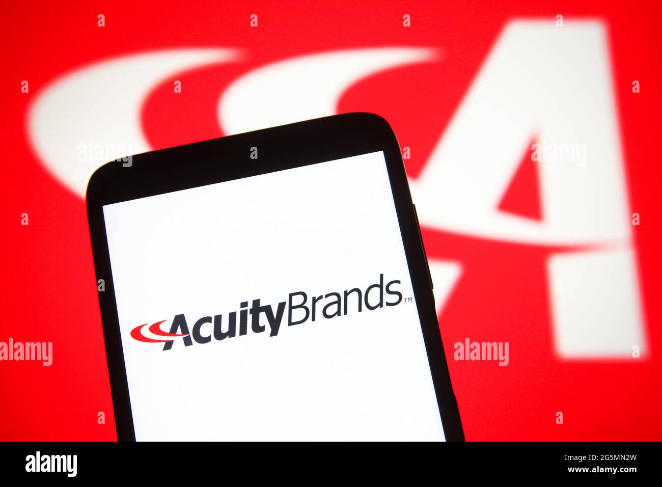 In this photo illustration, Acuity Brands logo is seen on a smartphone and a pc screen. (Photo ...