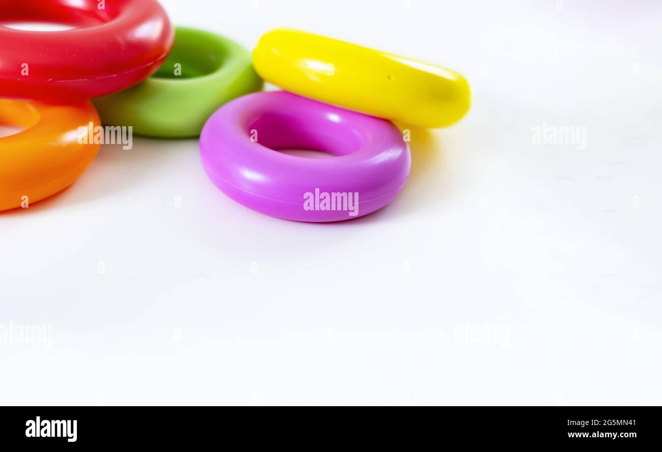 a group of of five colorful plastic rings isolated on a white ...