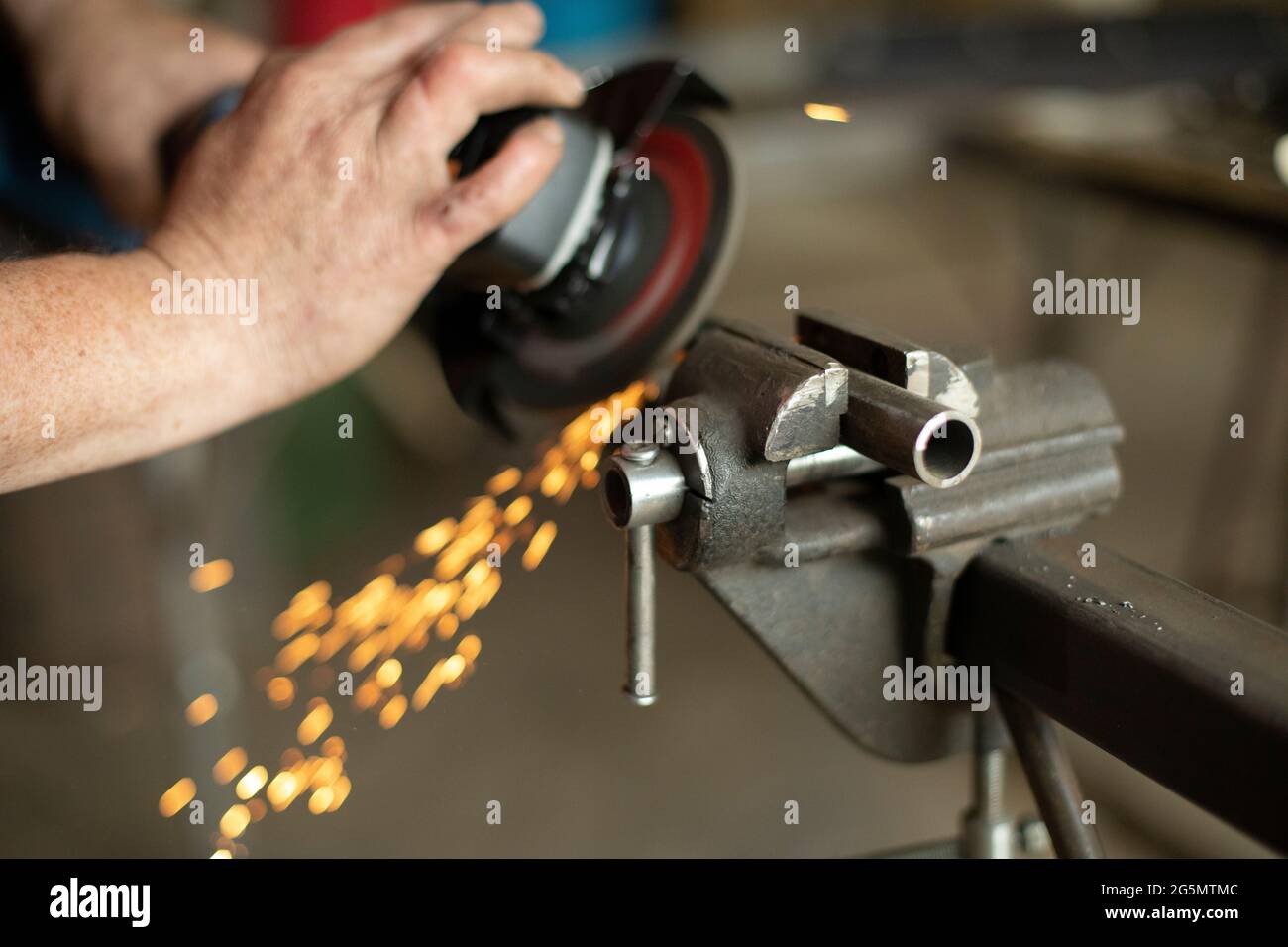 Metal grinding. Steel processing with power tools. A man is working on ...
