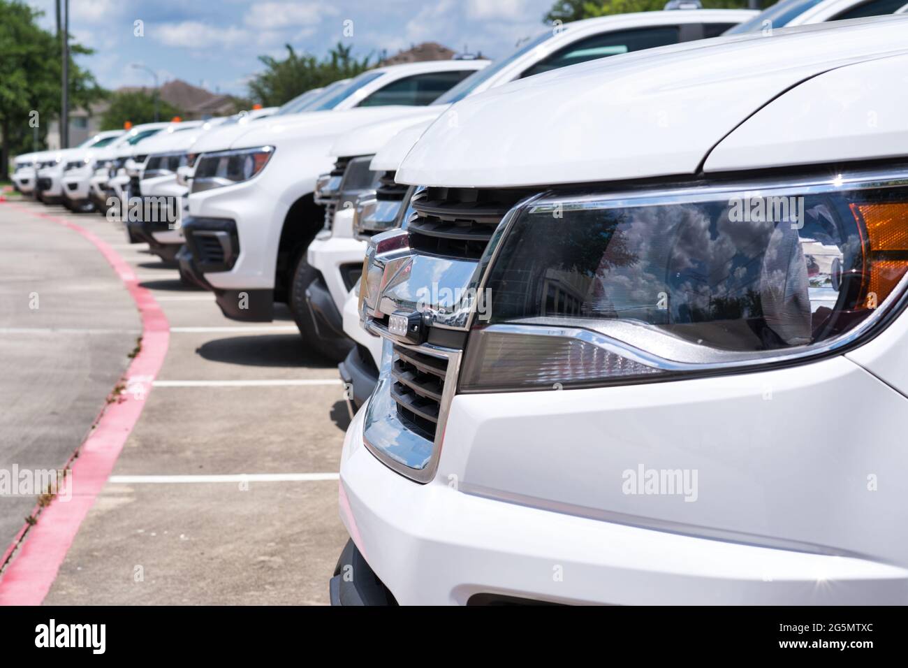 White generic fleet SUV's parked in a lot, side closeup on front of ...