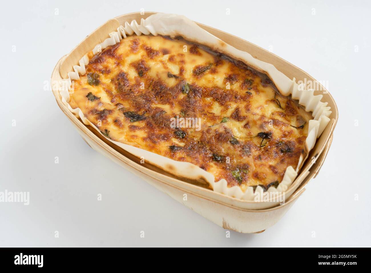 golden color on top of baked lasagne, ready to serve in wooden ...