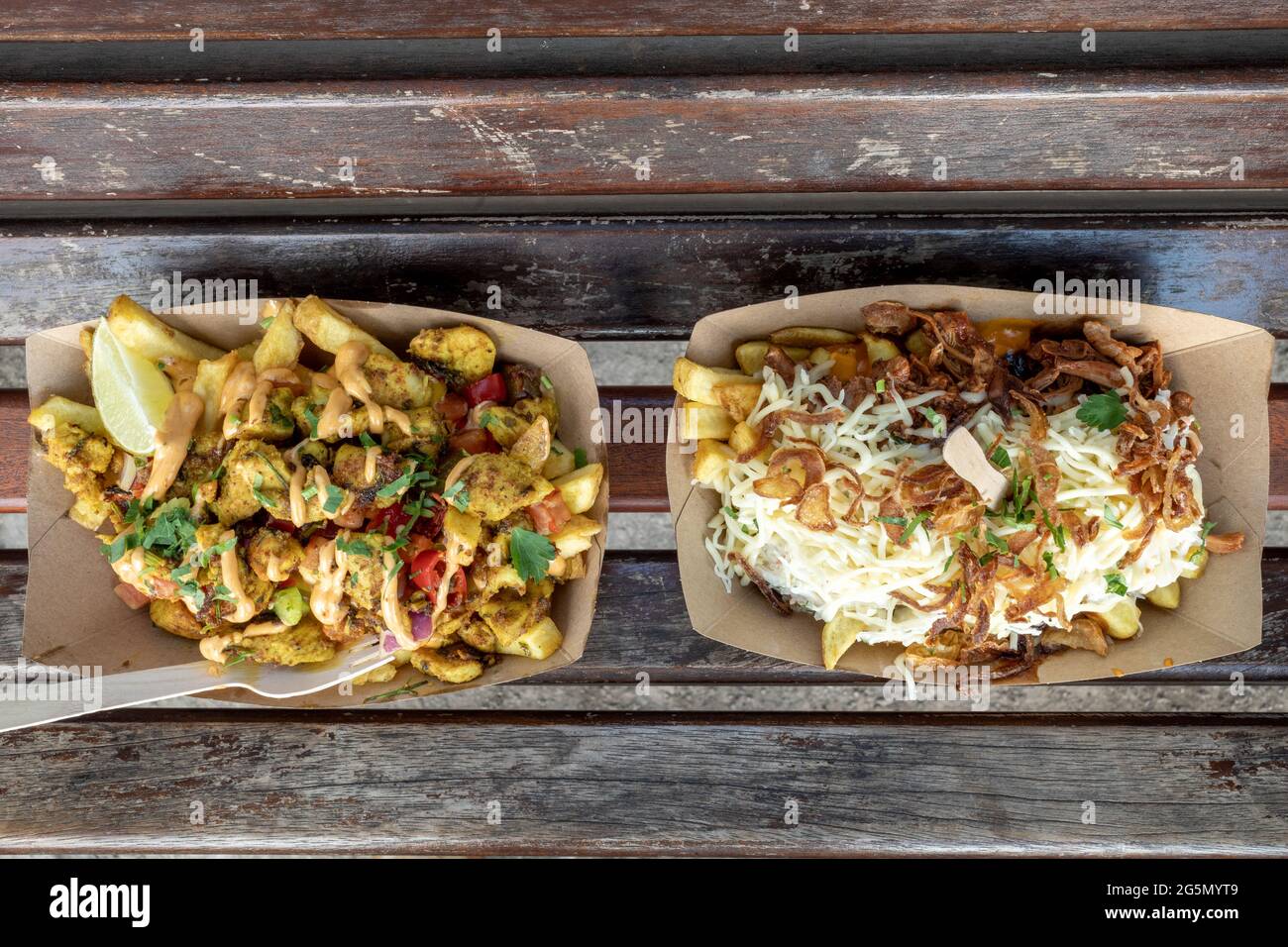 Top view of take away portions of fancy poutine, French fries on top ...