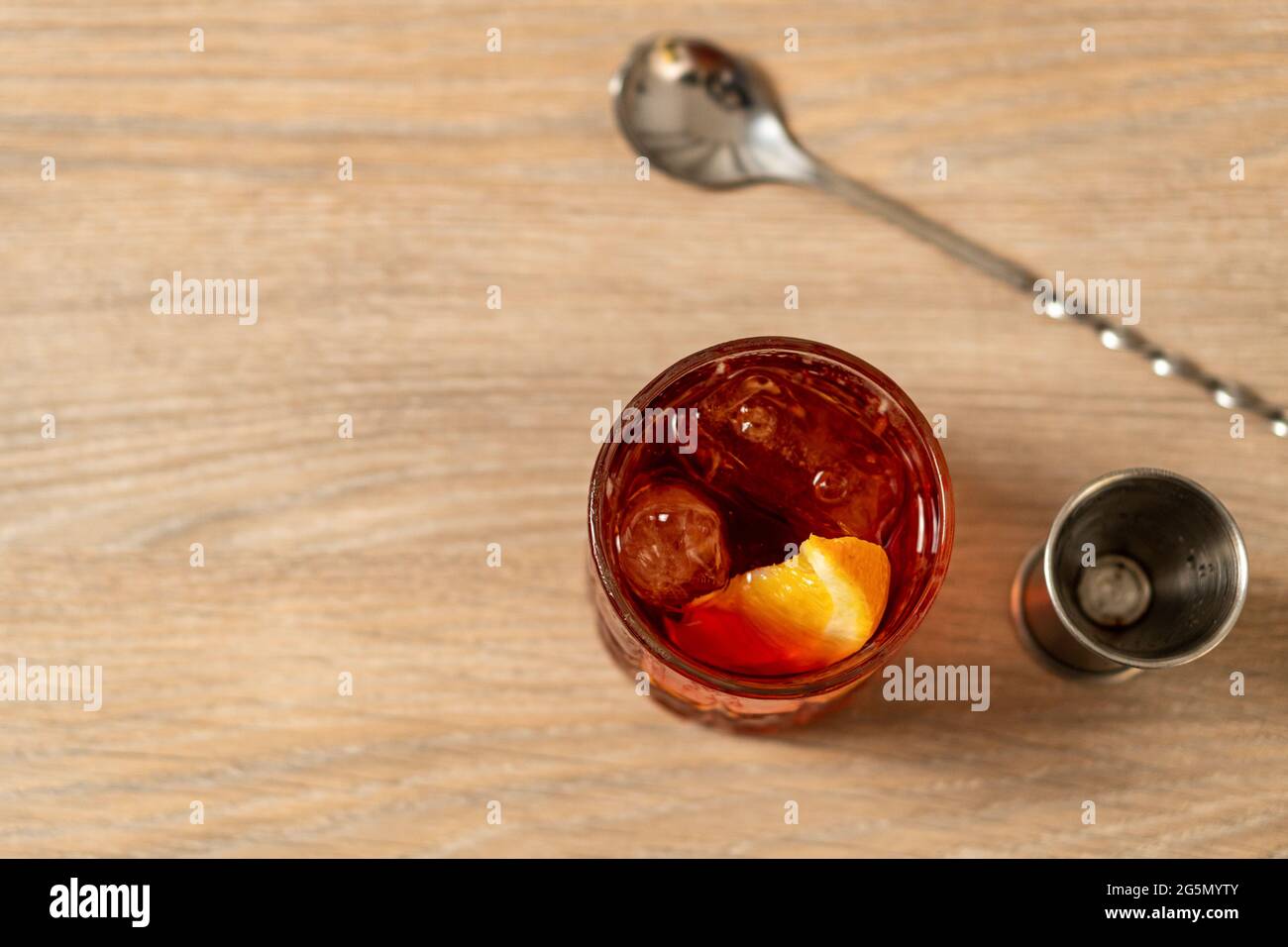 Top view of negroni cocktail with mixing spoon and jigger on wood ...