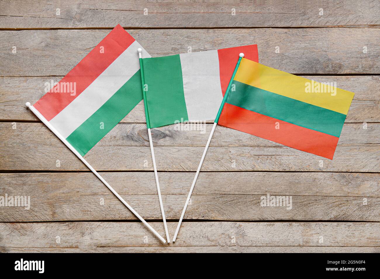 Different flags on wooden background Stock Photo - Alamy