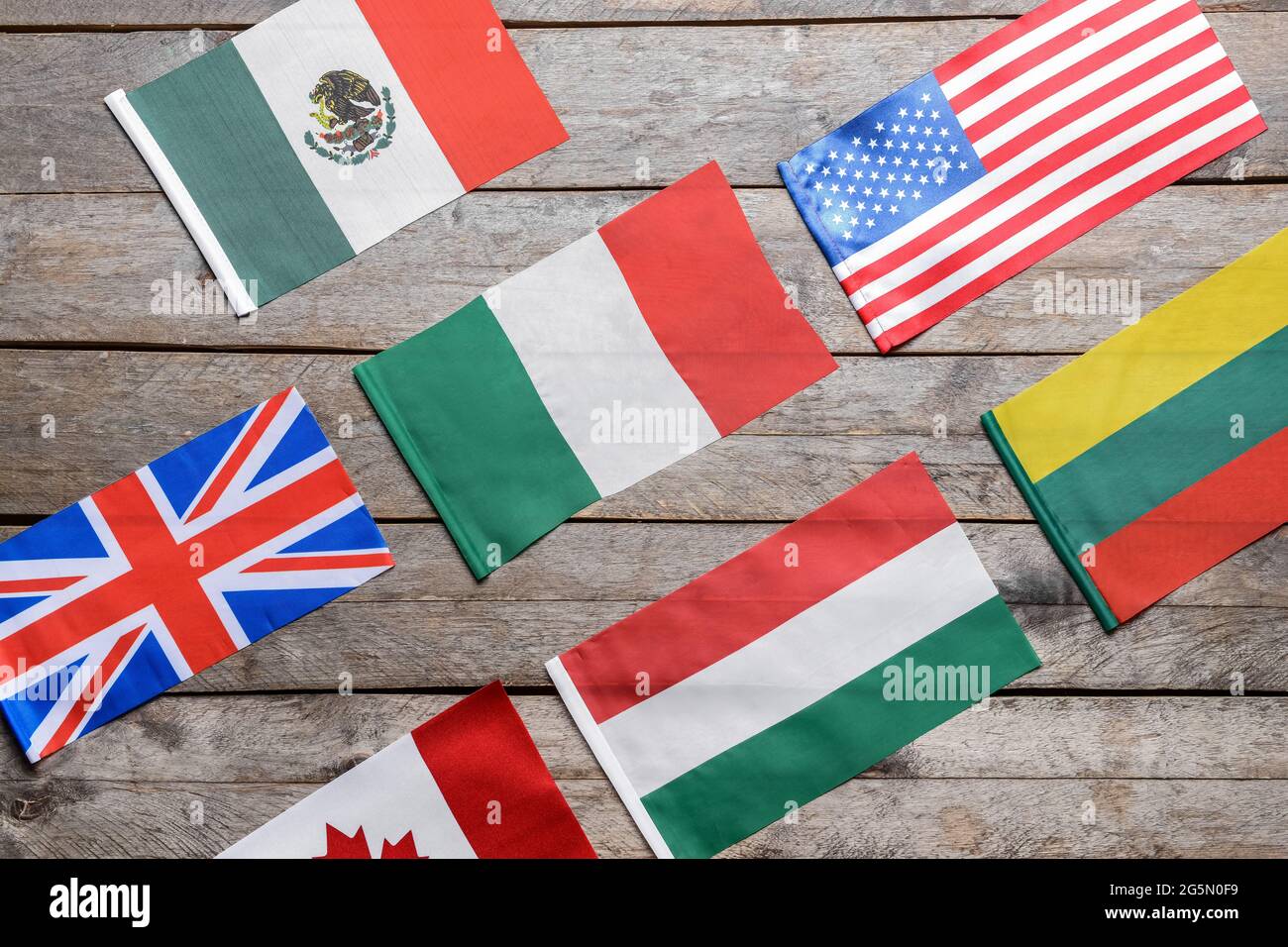Different flags on wooden background Stock Photo - Alamy