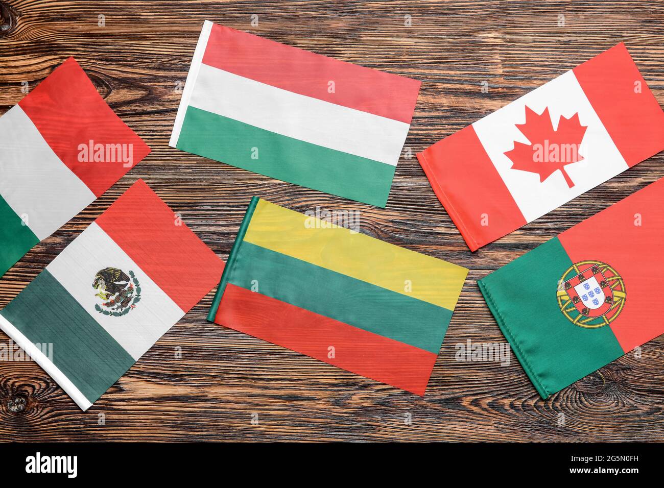 Different flags on wooden background Stock Photo - Alamy