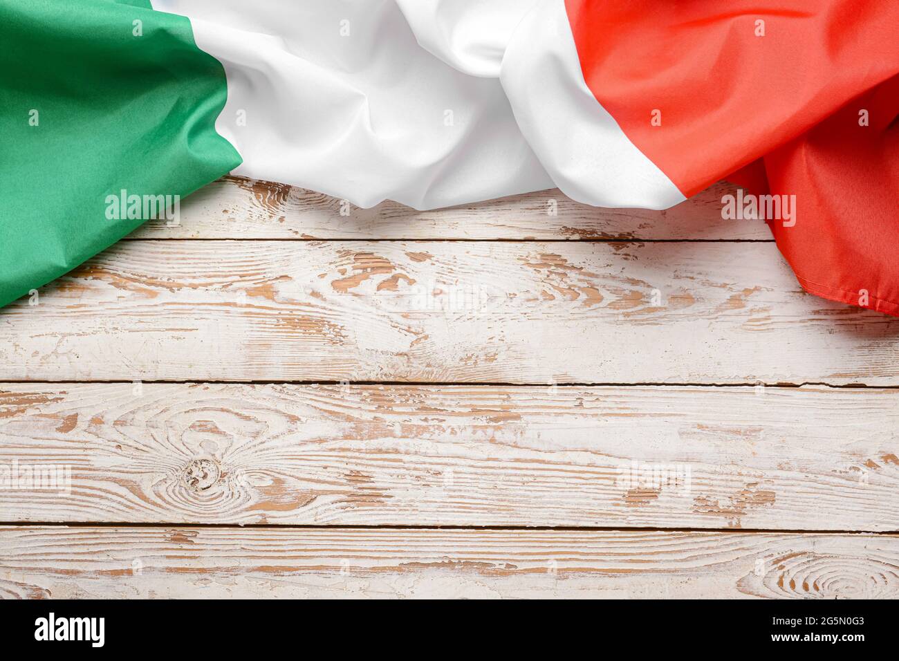 Italian flag on light wooden background Stock Photo - Alamy