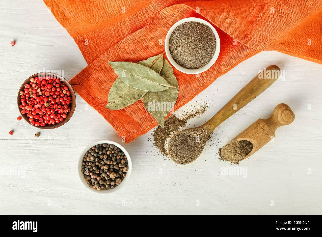 Composition with different types of pepper on light wooden background ...