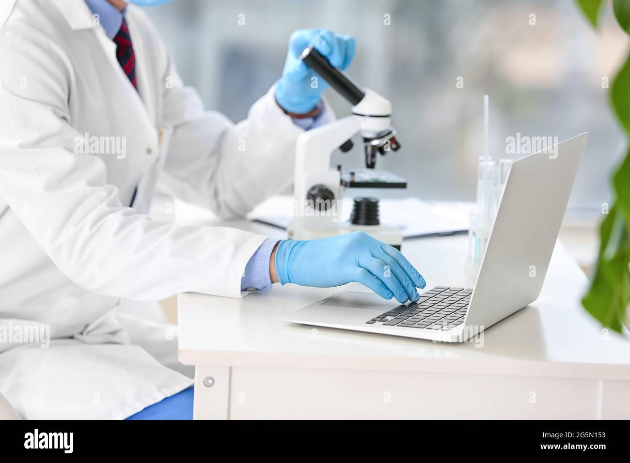 Male scientist using laptop in hi-res stock photography and images - Alamy