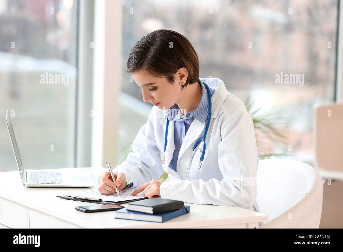 Female doctor working in clinic Stock Photo - Alamy