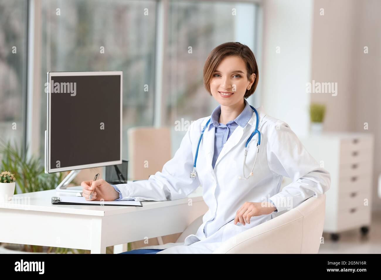 Female doctor working in clinic Stock Photo - Alamy