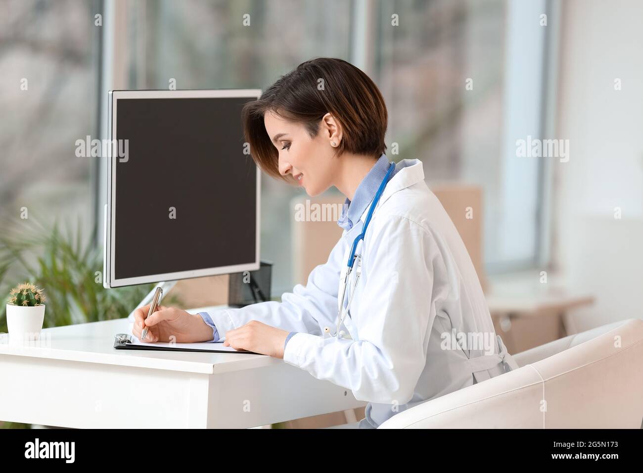 Female doctor working in clinic Stock Photo - Alamy