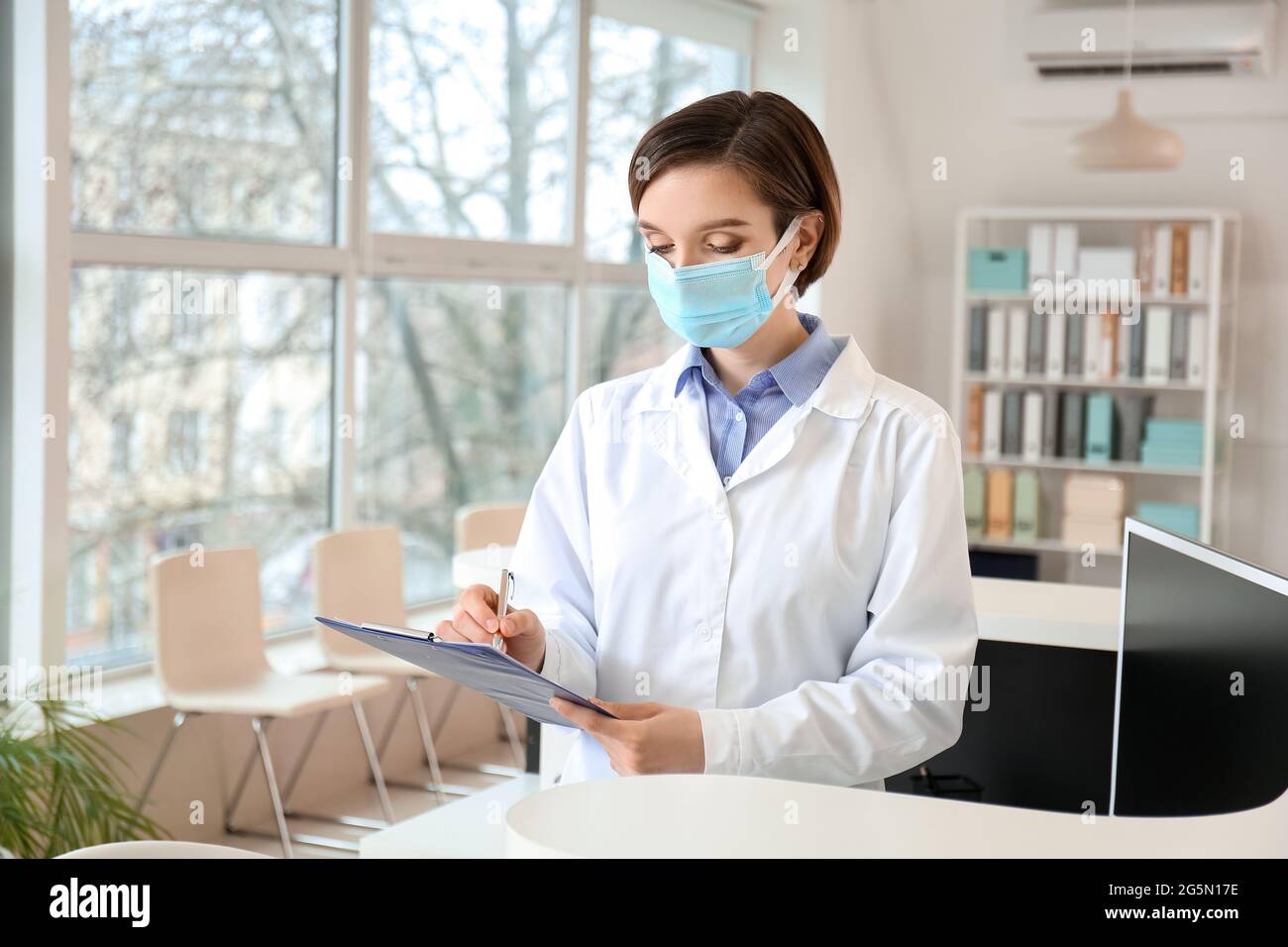 Female medical assistant working in clinic Stock Photo - Alamy