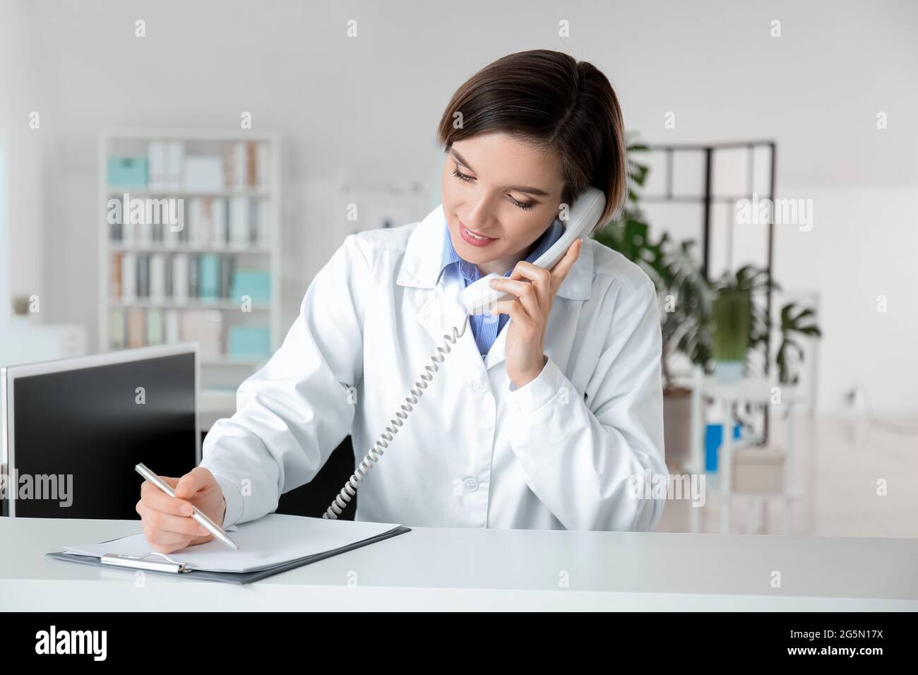 Female medical assistant working in clinic Stock Photo - Alamy