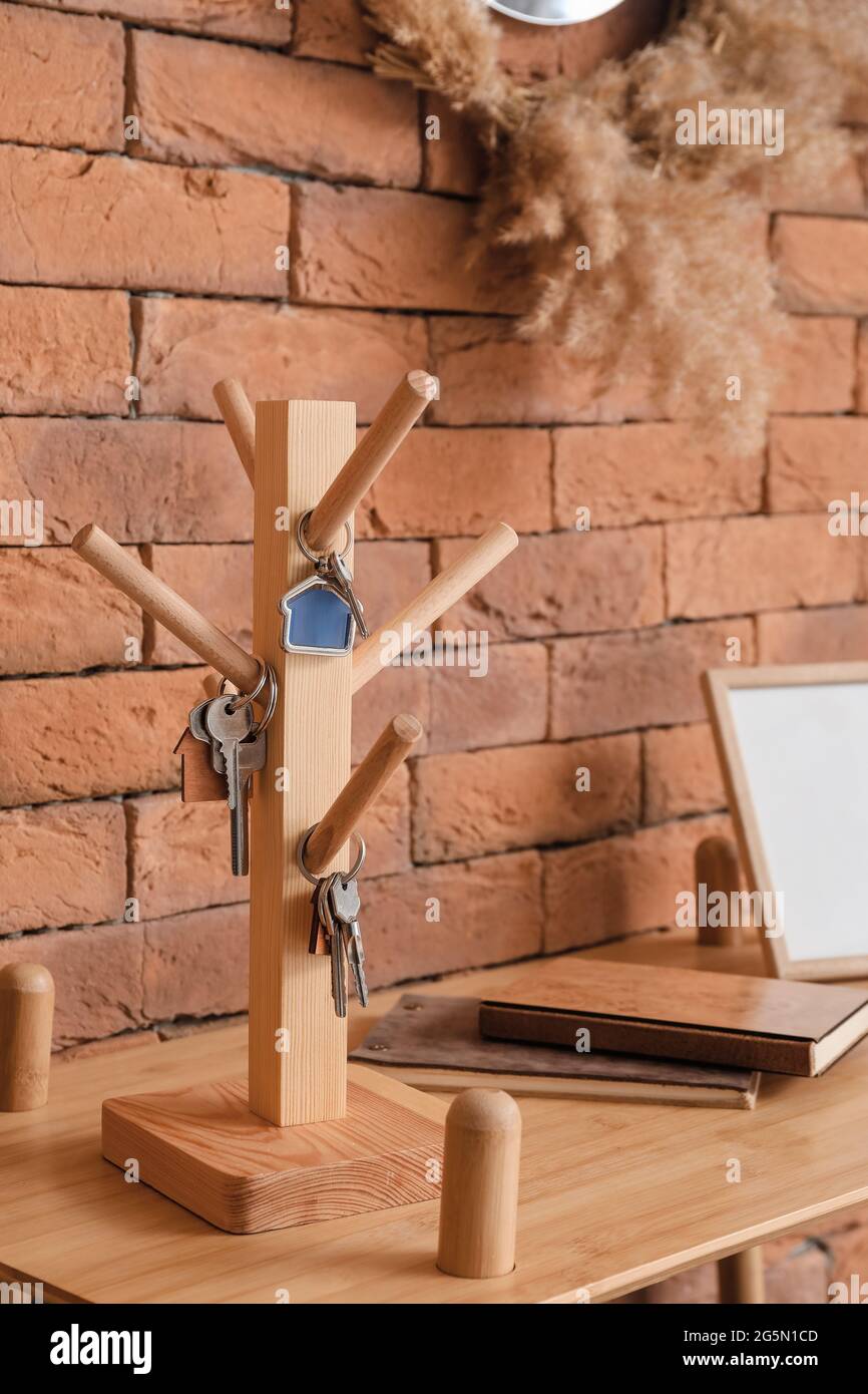 Holder with keys on table near brick wall Stock Photo - Alamy