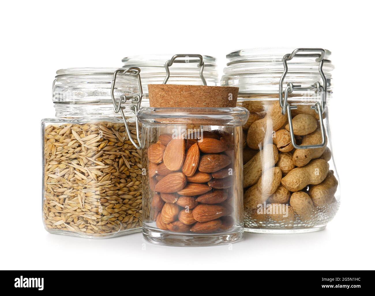 Glass jars with different products on white background Stock Photo - Alamy