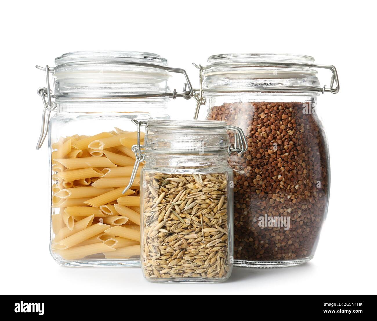 Glass jars with different products on white background Stock Photo - Alamy