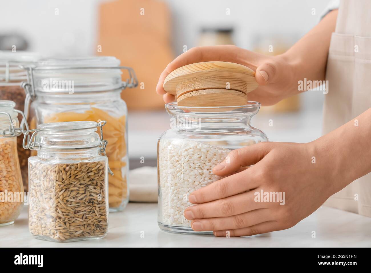 Female hands and jars with different products in kitchen, closeup Stock ...