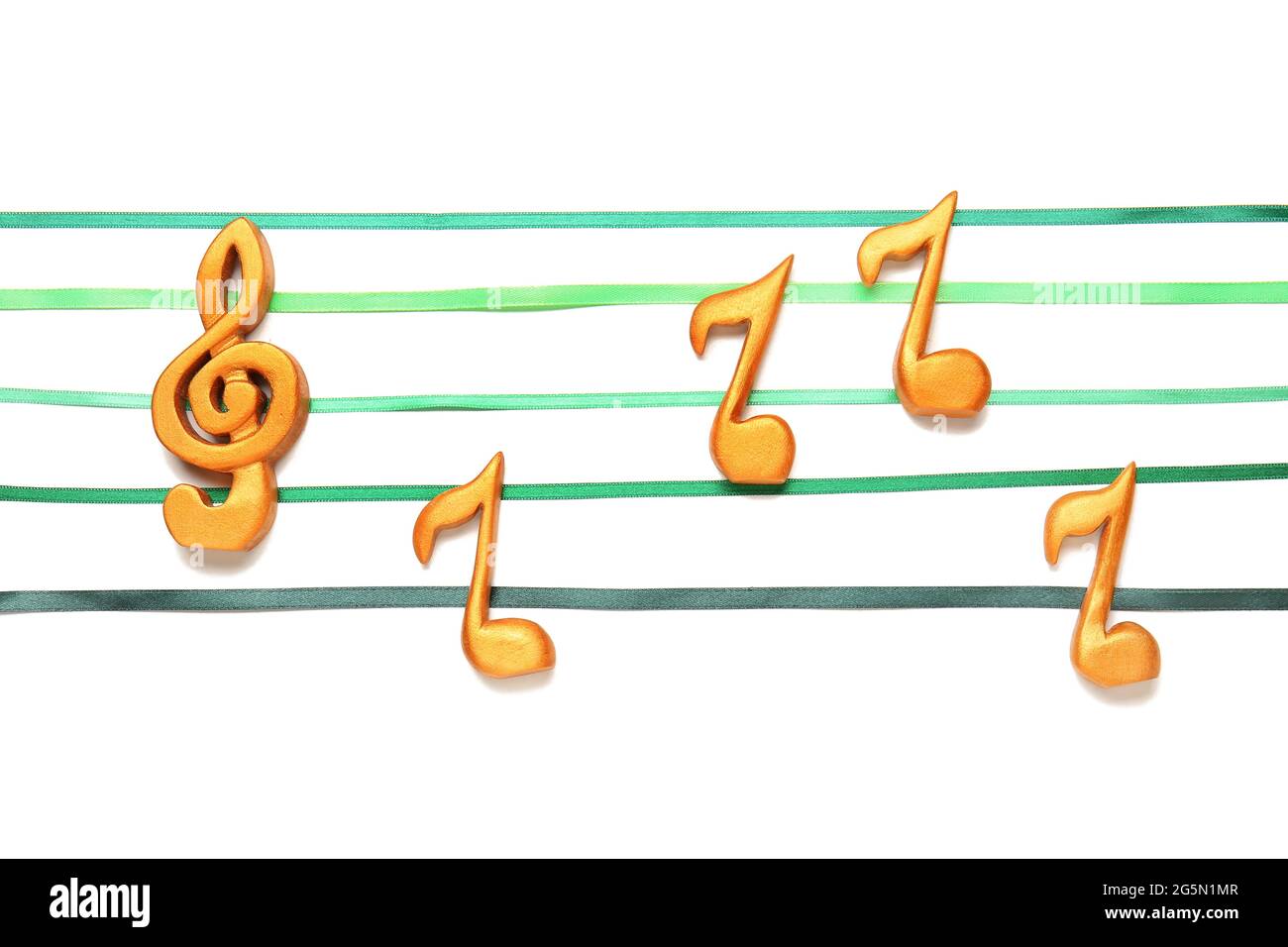 Composition with music notes and green ribbons on white background ...