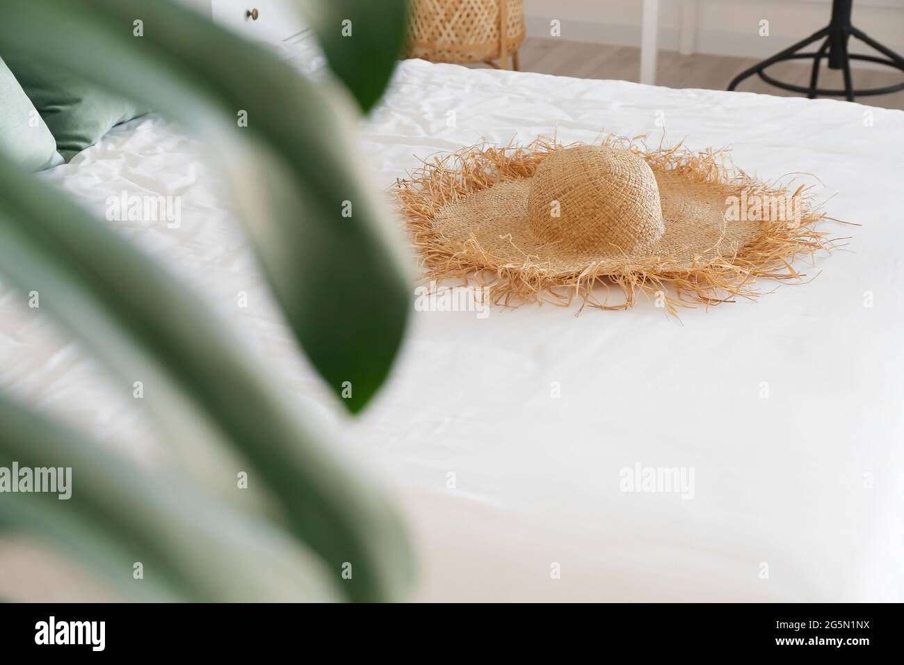 Stylish hat on bed in bedroom Stock Photo - Alamy