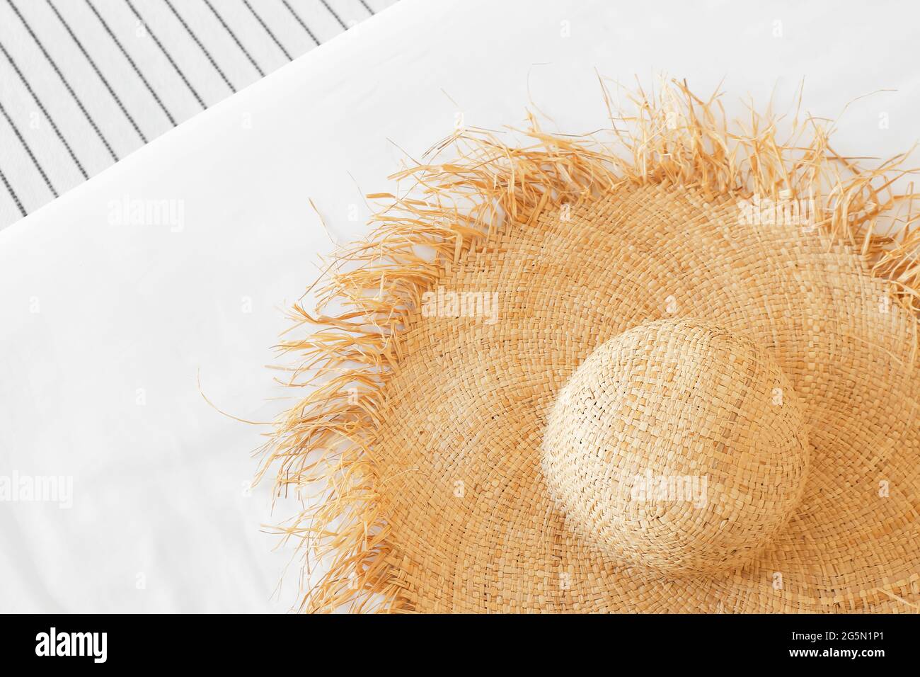 Stylish hat on bed in bedroom, closeup Stock Photo - Alamy
