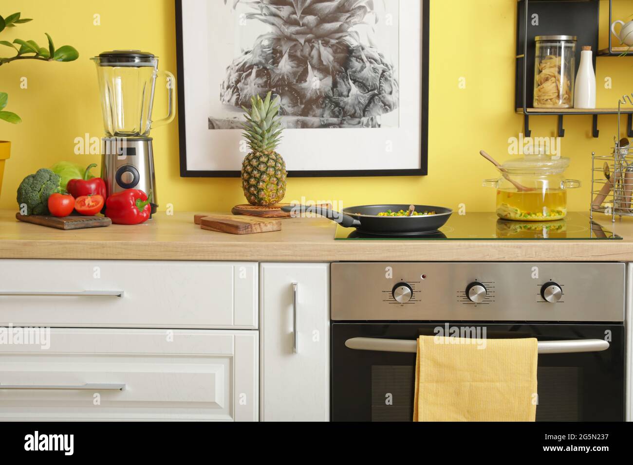 Modern electric stove and utensils in kitchen Stock Photo - Alamy