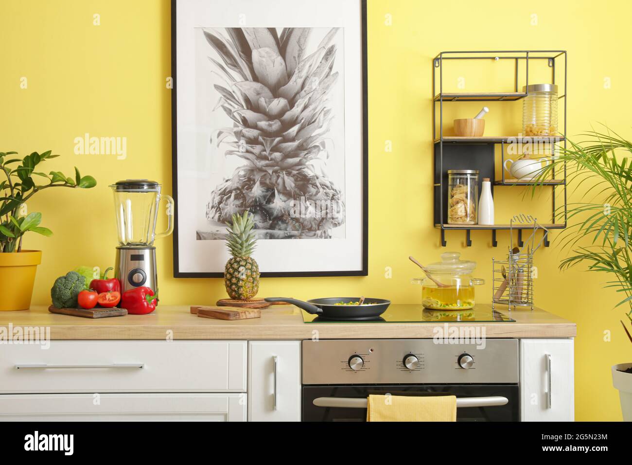 Modern electric stove and utensils in kitchen Stock Photo - Alamy