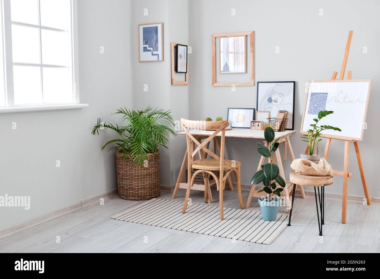 Interior of stylish room with modern workplace and pictures Stock Photo ...