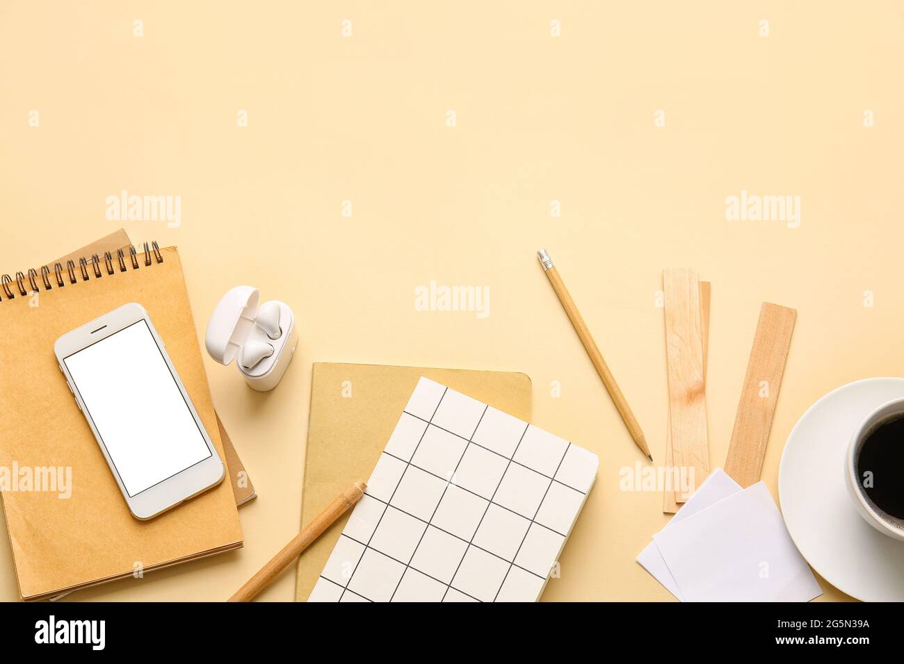 Different office tools and devices on color table Stock Photo - Alamy