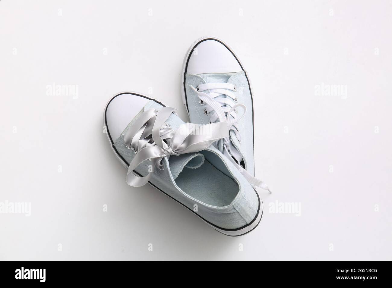 Stylish shoes with silver ribbon on white background Stock Photo - Alamy