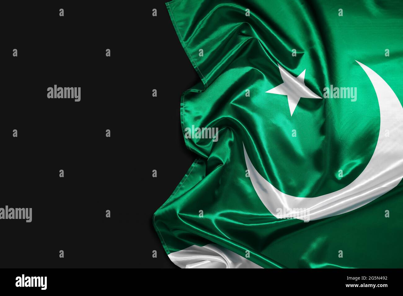 Pakistan flag on dark background Stock Photo - Alamy