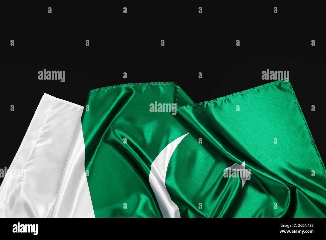 Pakistan flag on dark background Stock Photo - Alamy