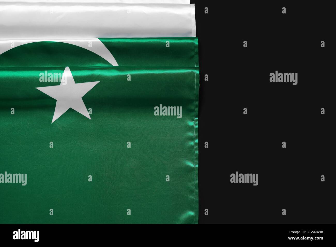 Pakistan flag on dark background Stock Photo - Alamy
