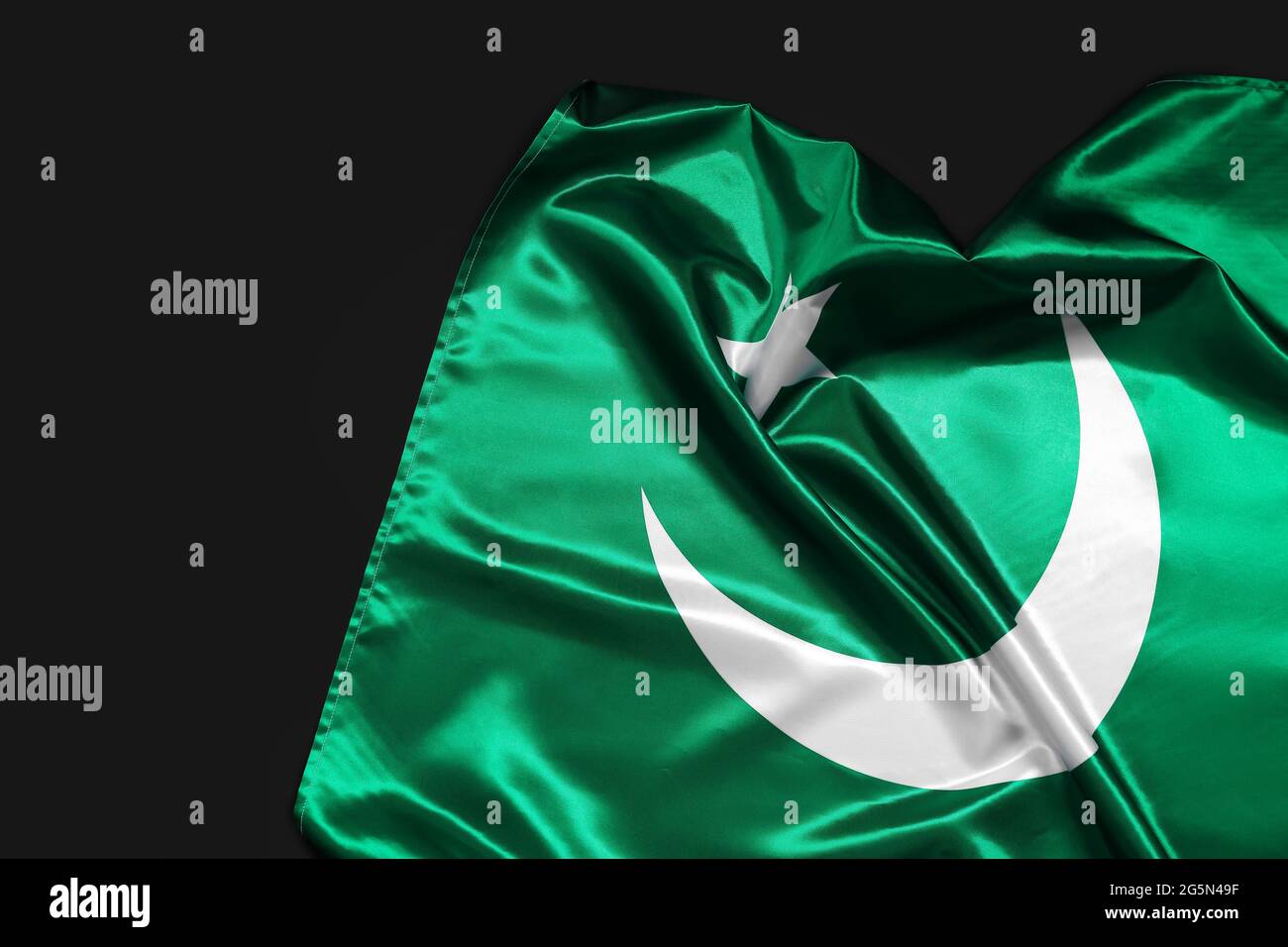 Pakistan flag on dark background Stock Photo - Alamy