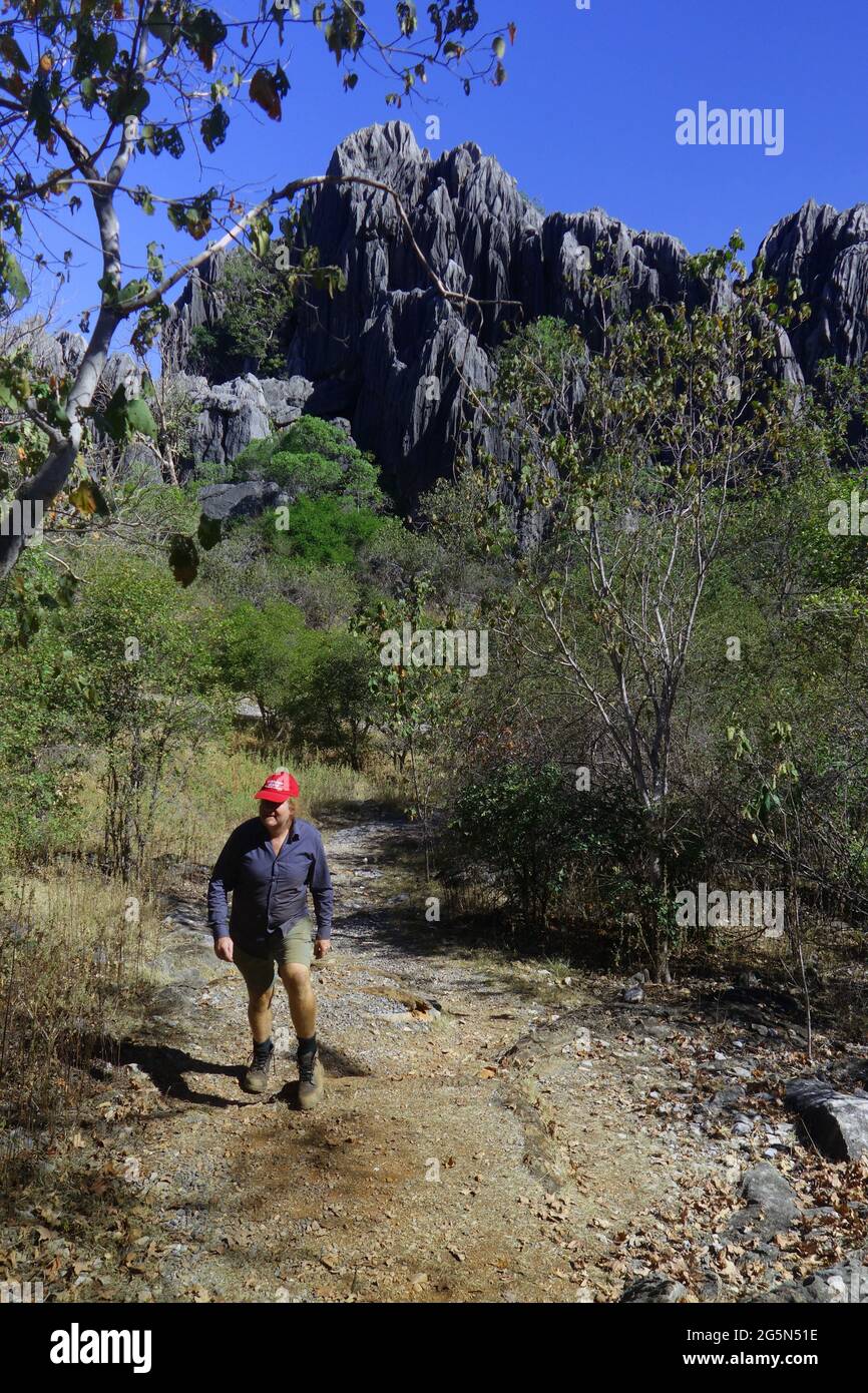 Hiker on track amongst karst rock formations, Wakaman country, Chillago ...