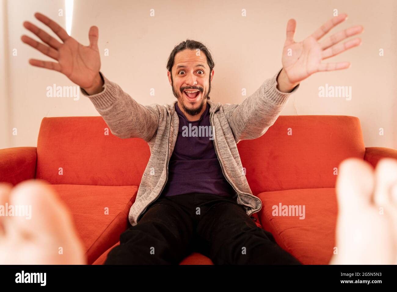Young man with extreme happy face celebrating with open arms and legs ...