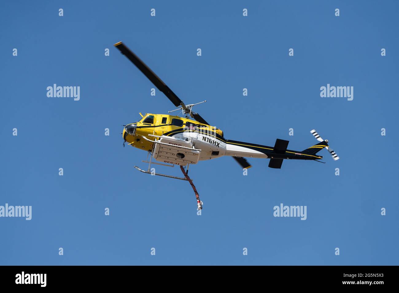 A Bell 205-A1 helicopter configured for aerial fire suppression with a ...