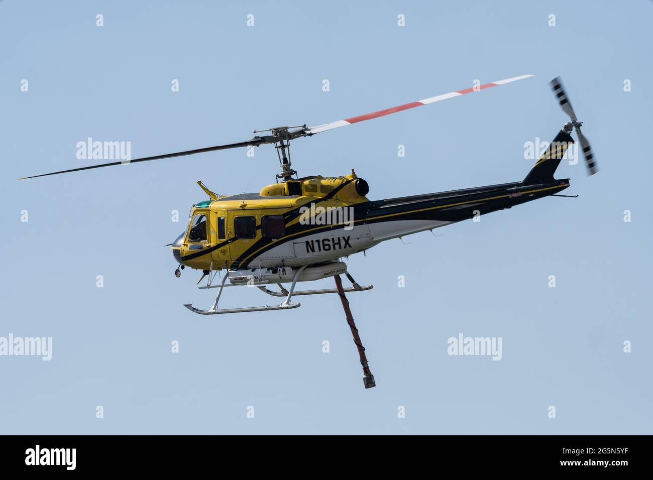 A Bell 205-A1 helicopter configured for aerial fire suppression with a ...