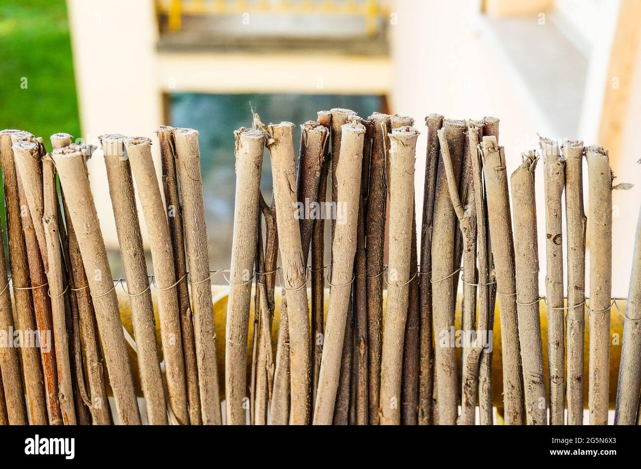Closeup of wooden stick fence of a house Stock Photo - Alamy