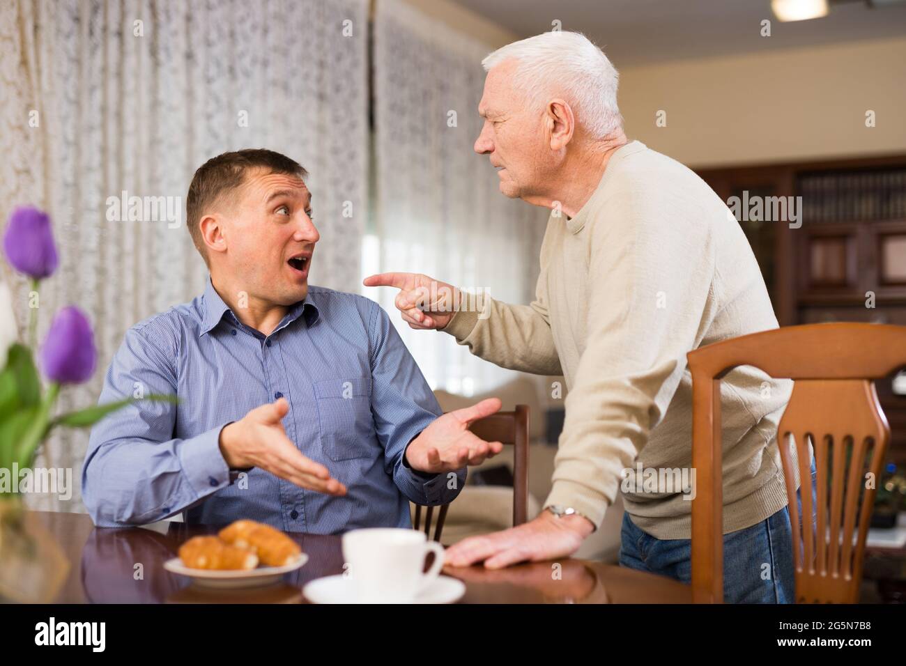Misunderstanding between senior father and son Stock Photo - Alamy
