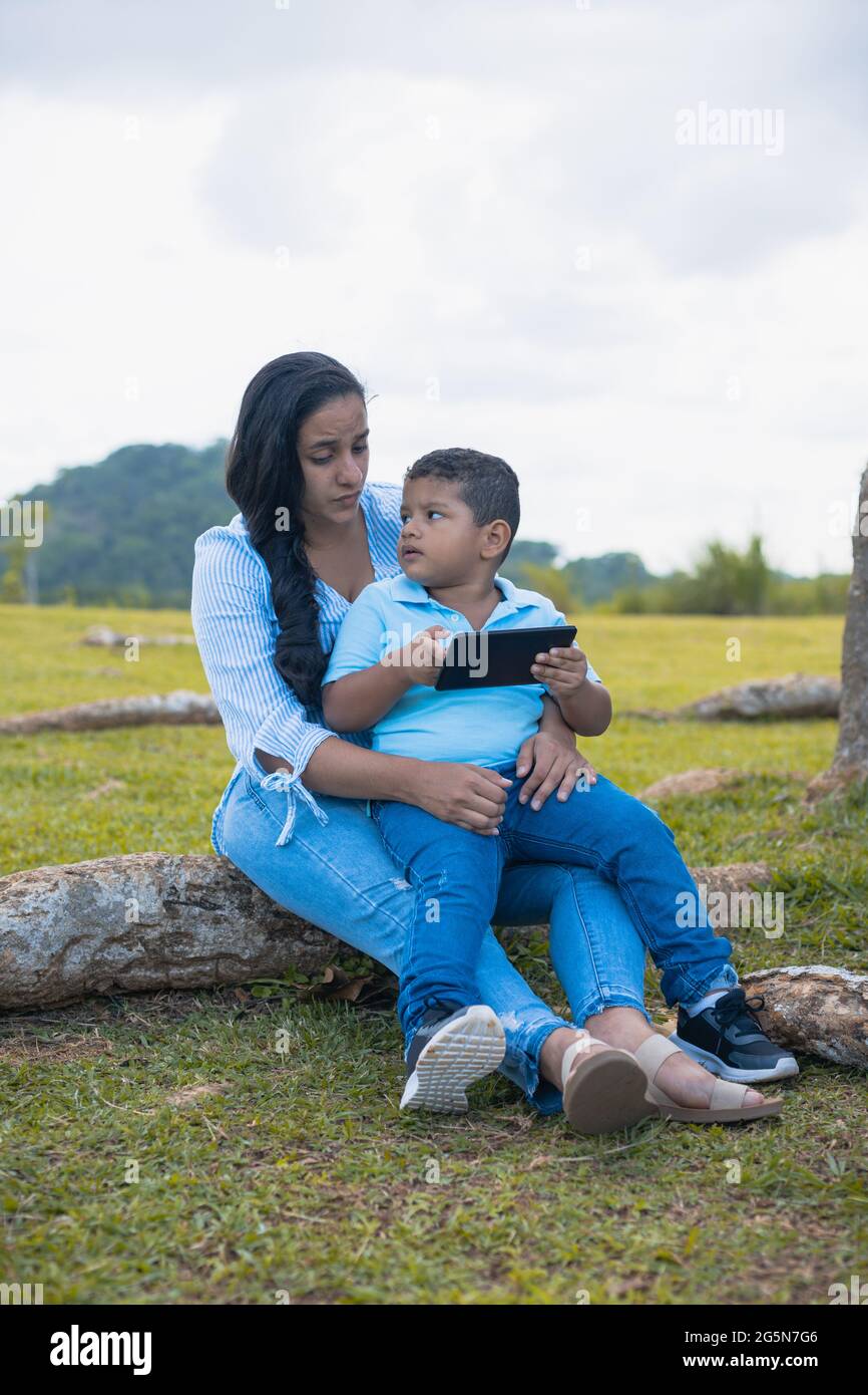 mom and son watching the tablet Stock Photo - Alamy