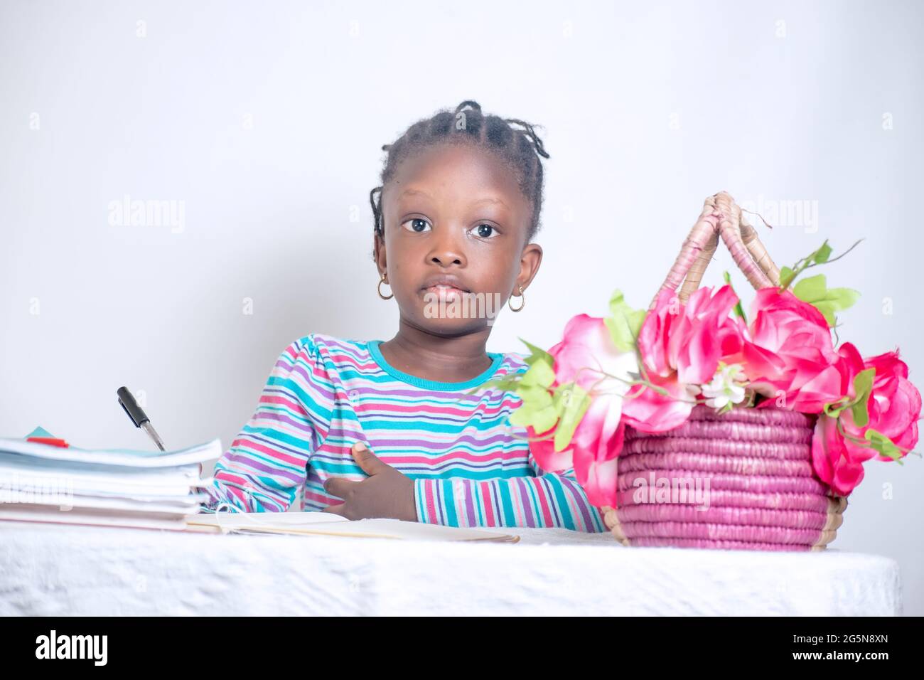 Close up education picture of an African girl child with woven hair ...