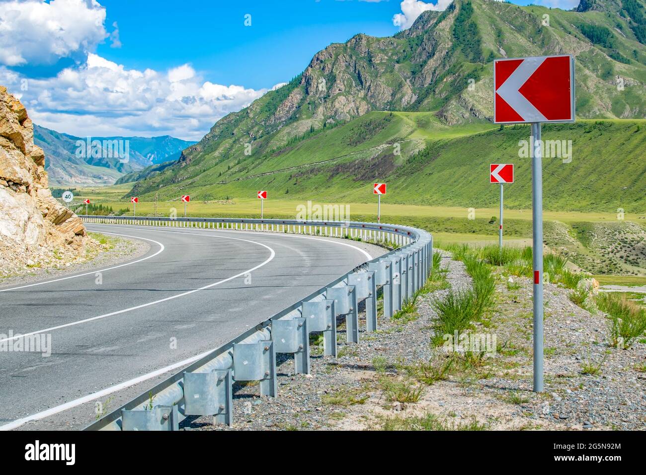a lot of signs, symbols warning about a dangerous and sharp turn of the ...