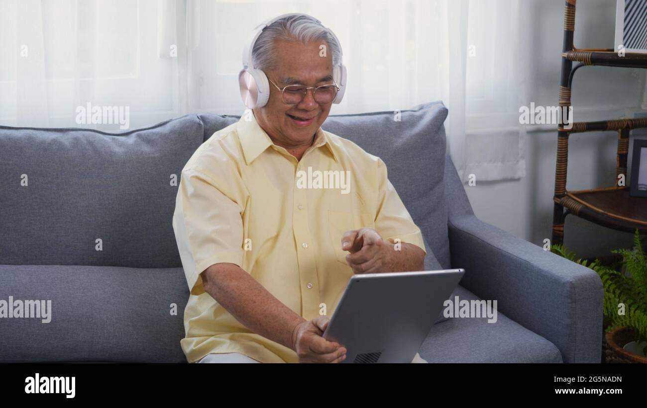 Old man grandfather smile with eyeglasses relaxing wear headphones is ...