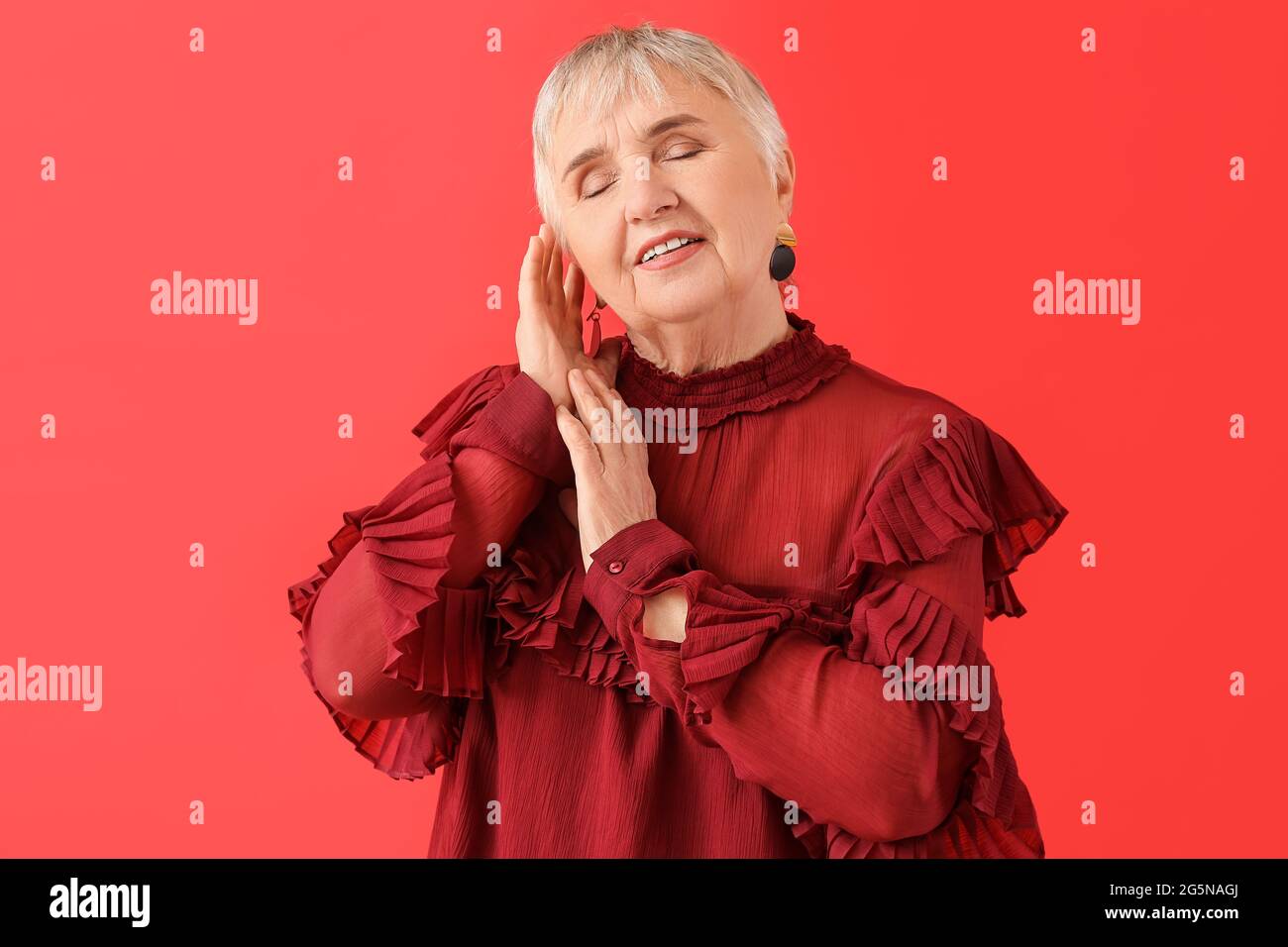 Portrait of stylish senior woman on color background Stock Photo - Alamy
