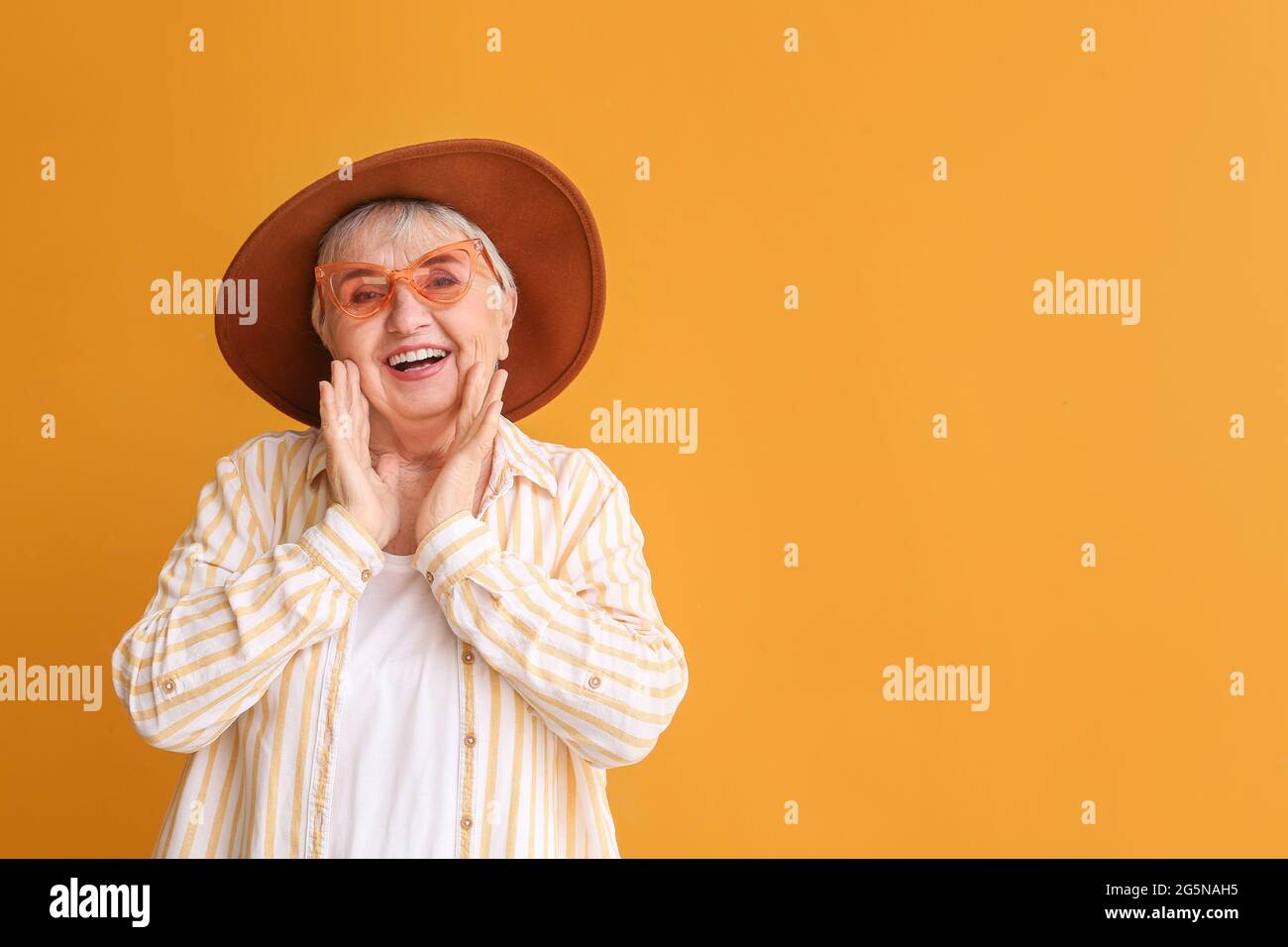 Portrait of stylish senior woman on color background Stock Photo - Alamy