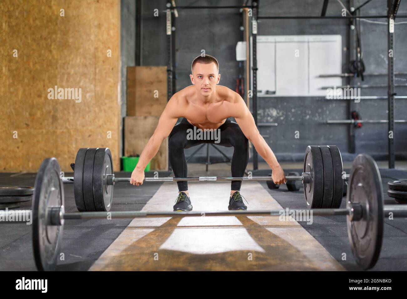 The man before the barbell snatch. Sport and healthy lifestyle concept ...