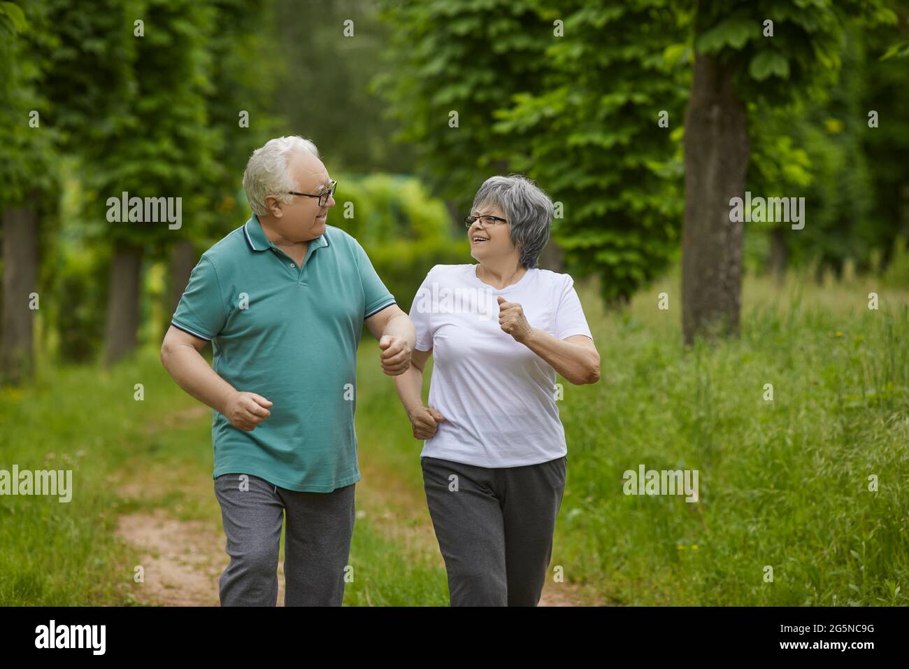 Happy healthy senior people enjoying an active running workout in a ...