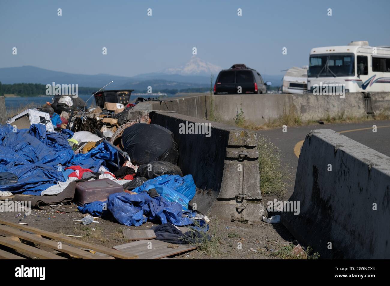 Garbage builds up at a homeless camp along Northeast Marine Drive in ...