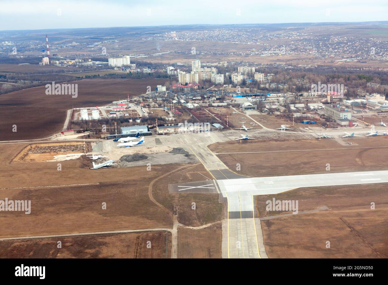 Old airfield at the edge of the city . Old planes in the hangar ...